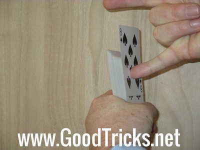 Hold pack facing spectator keeping pinky out of view.